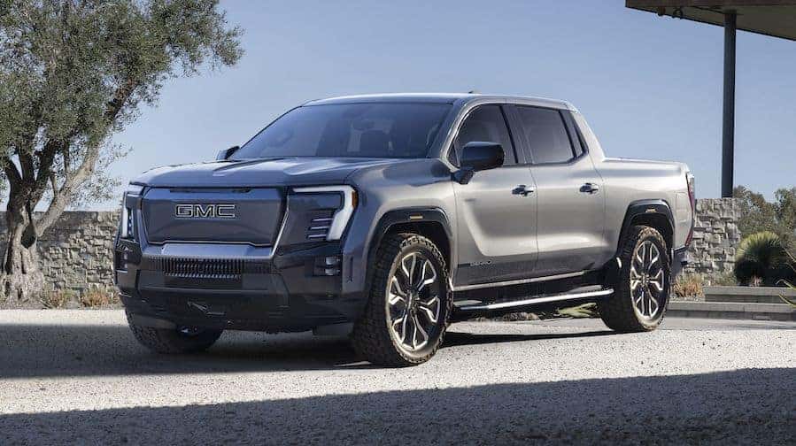How does the GMC Sierra 1500 EV compare to the Ford F-150 Lighting?